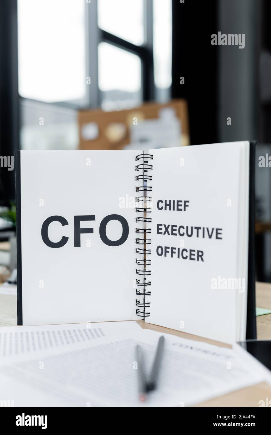 notebook with cfo and chief executive officer lettering on desk Stock ...