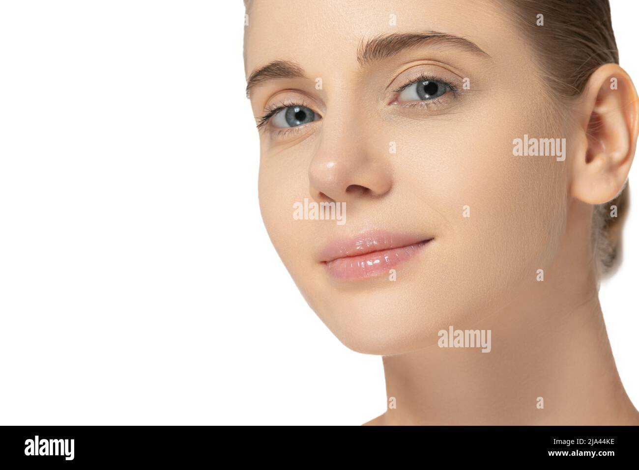 Close-up portrait of young beautiful woman with clean skin looking at ...