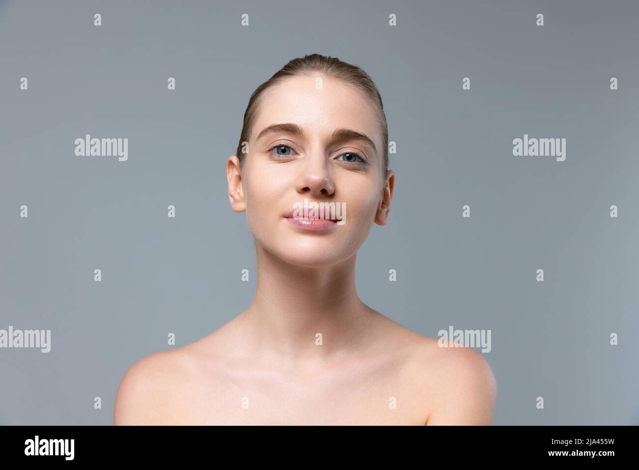 Portrait of young beautiful girl with no makeup face looking at camera ...