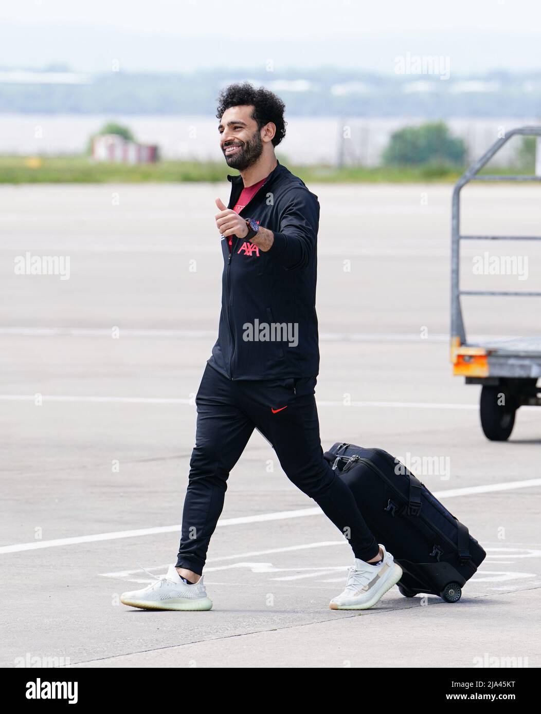 Liverpool's Mohamed Salah boards the plane before flying out of John ...