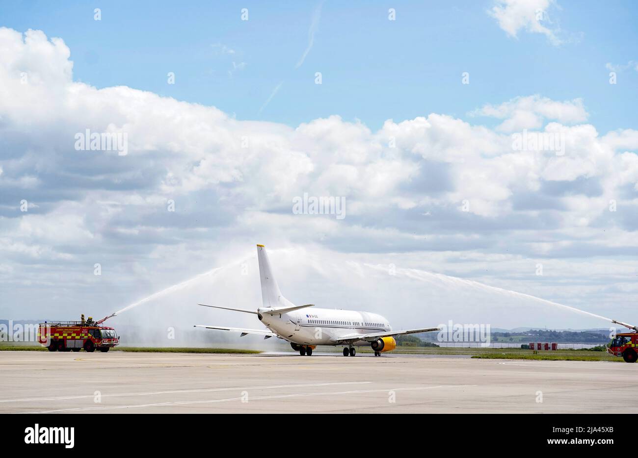 The Fire Brigade spray water cannons over the Liverpool plane before it ...