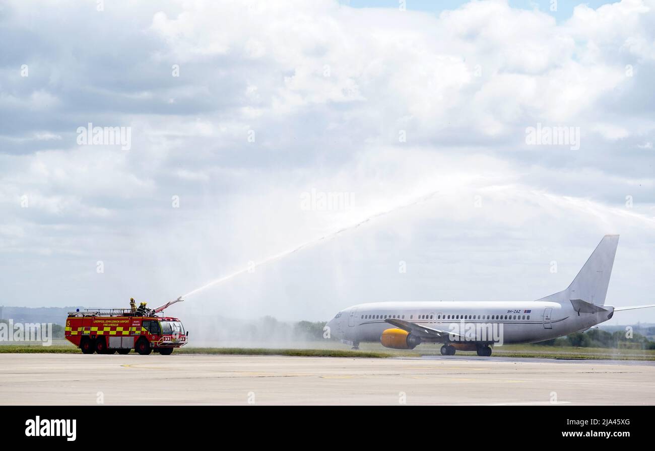 The Fire Brigade spray water cannons over the Liverpool plane before it ...