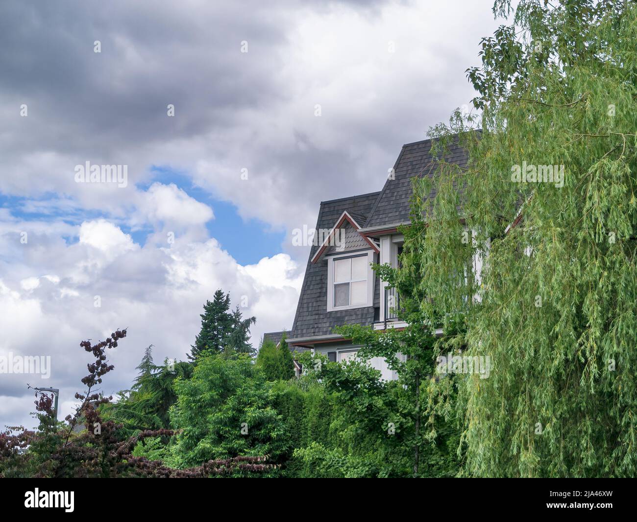 Top of residential building with window on the roof Stock Photo - Alamy