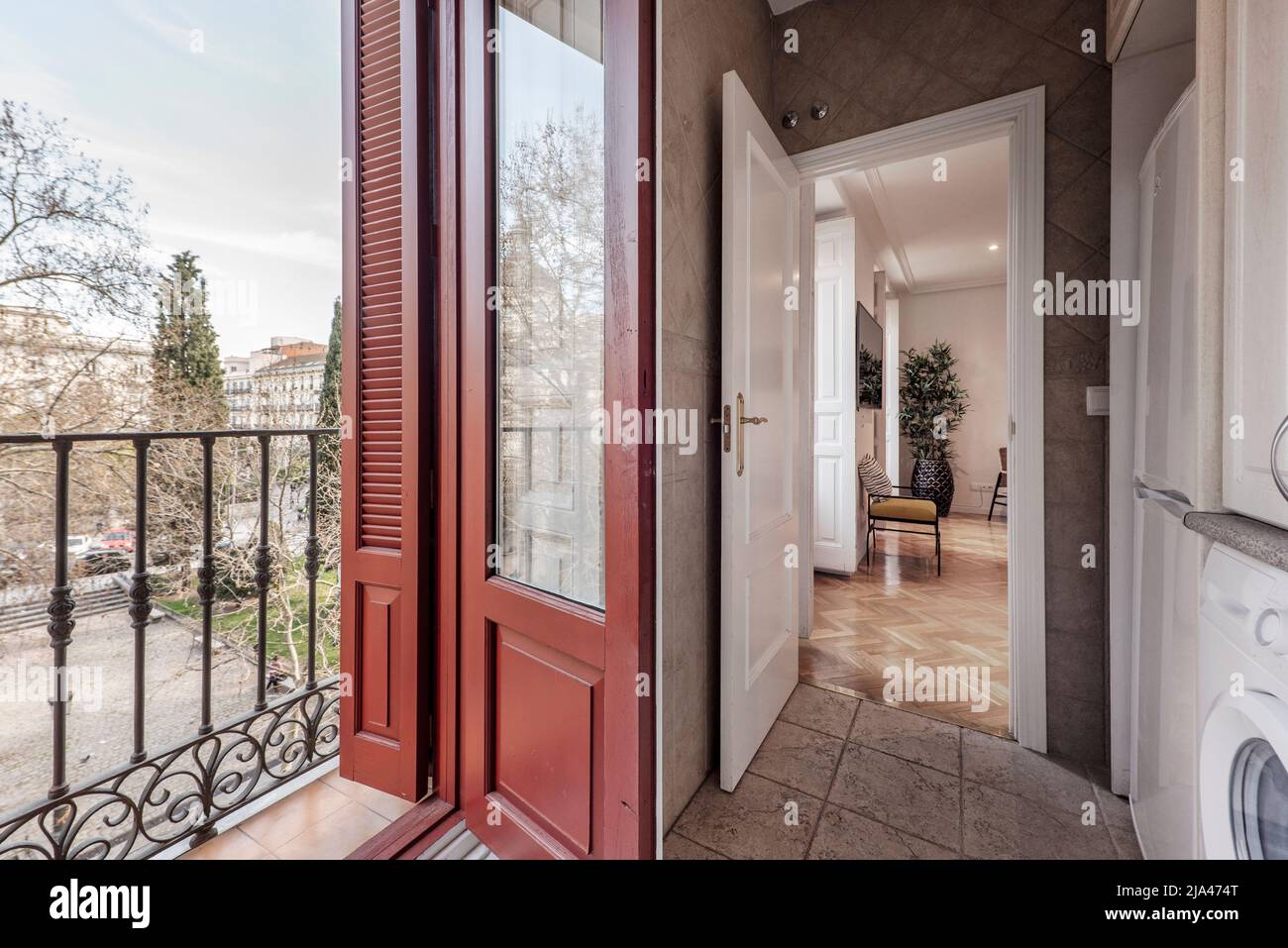 Balcony overlooking a square in a house with an ironing room next to a ...