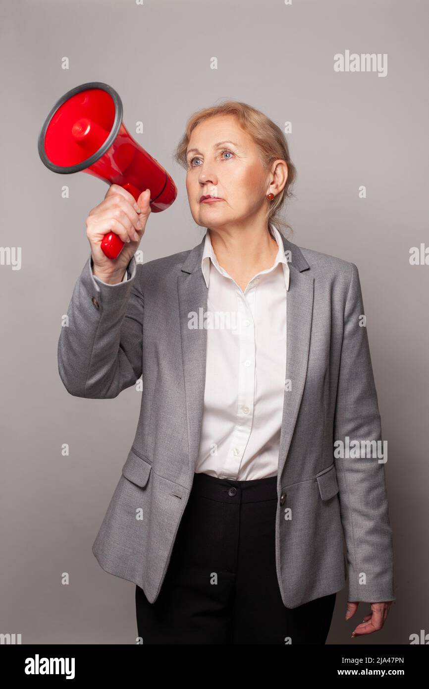 Business woman making announcement with megaphone or loudspeaker Stock ...