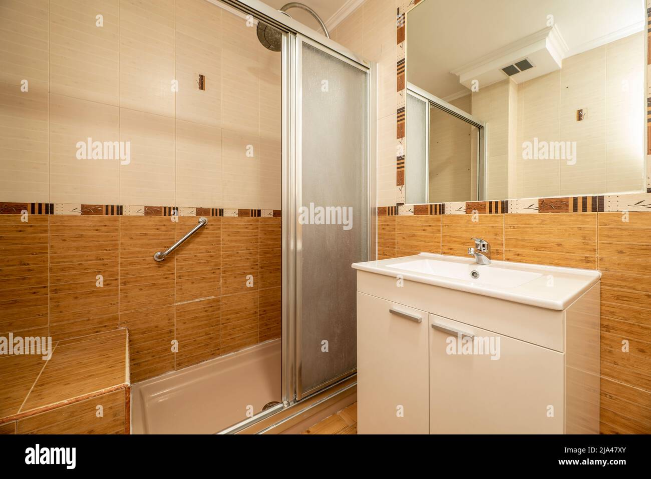 Bathroom with square mirror embedded in the wall, porcelain sink with ...