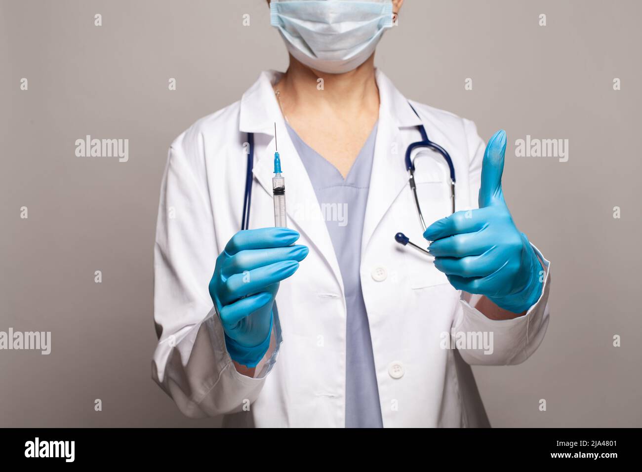 Doctors hands with injection, doctor holding syringe and showing thumb ...