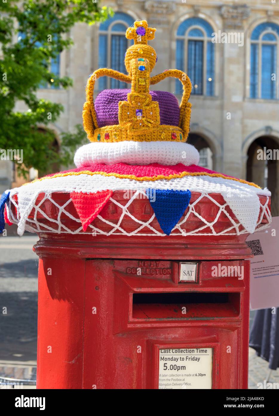 Unfortunate kawaii. Kitsch knitted crown decoration on a post box in ...