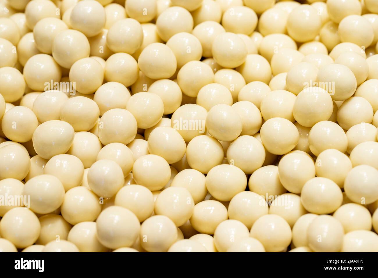 White chocolate dragee. Hazelnuts with white chocolate filling. Sweet ...