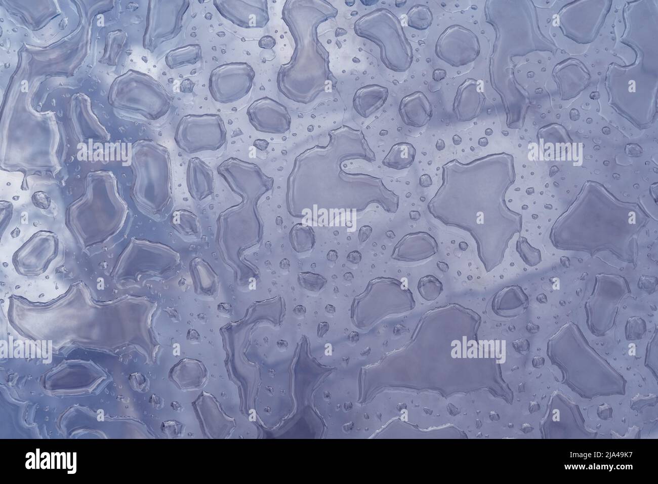 Close-up water drops pattern on glass surface abstract background ...