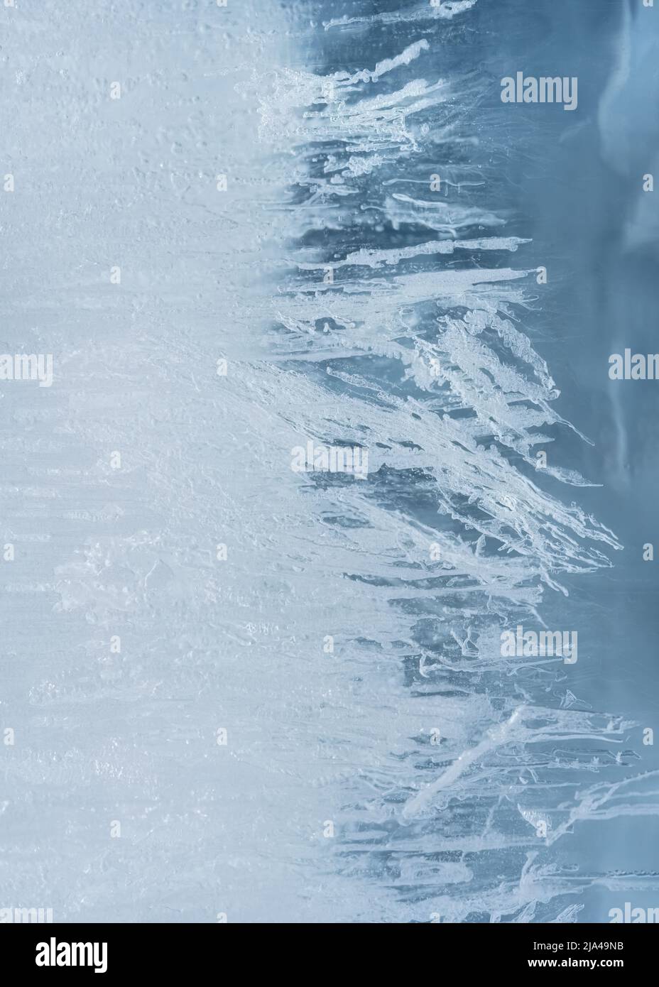 Macro photo of transparent light blue ice of frozen Baikal lake with ...