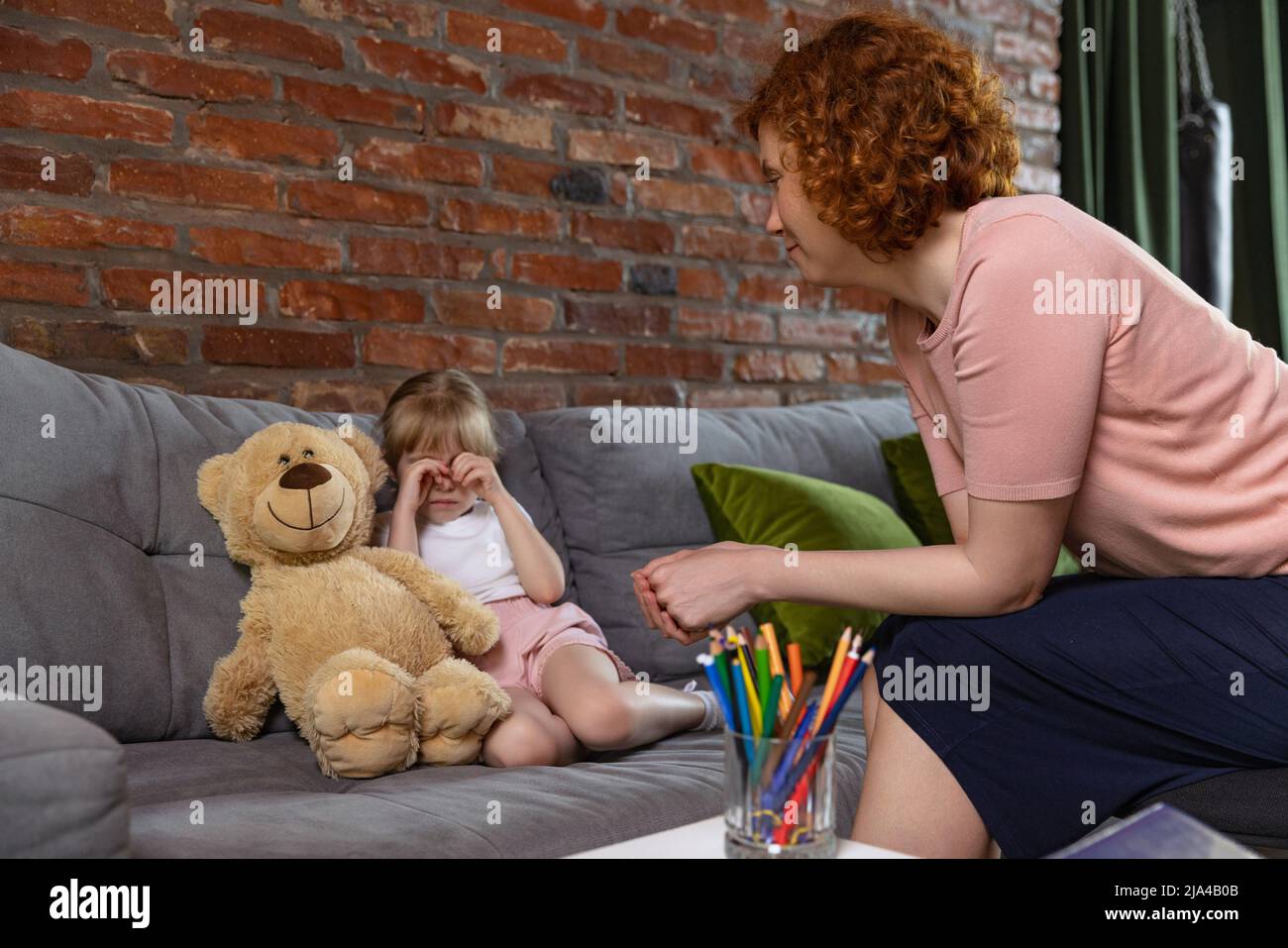 children's fears and resentments. Young red-headed woman and little ...