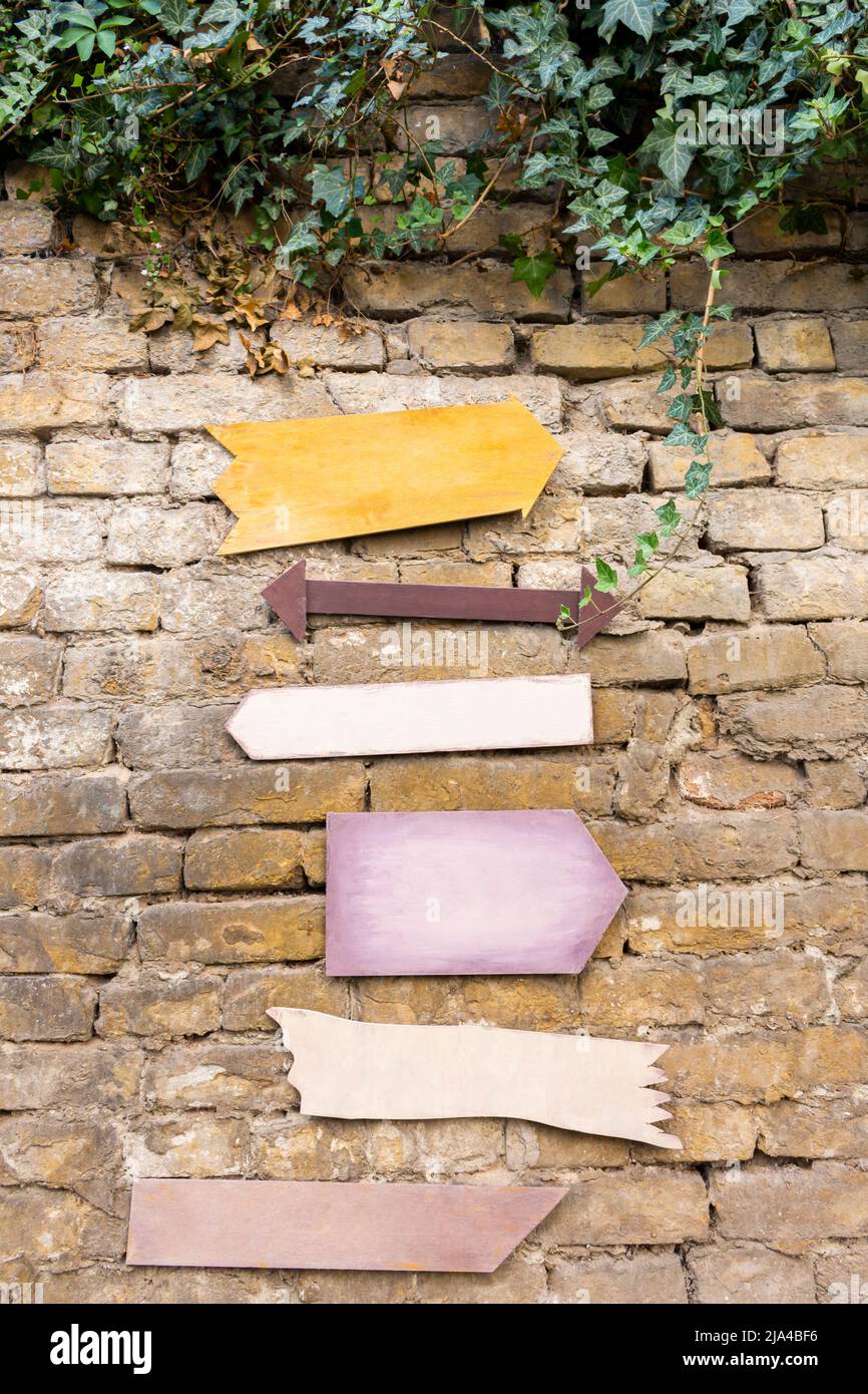 Wooden signs hanging on a rustic brick wall. Emty space, add text or ...