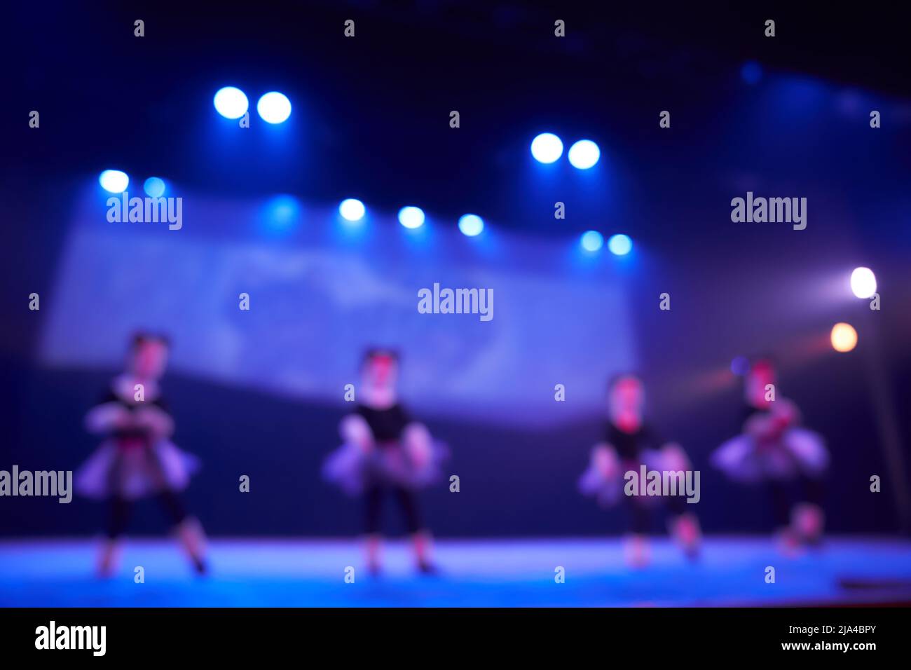 A blurry abstract background of a dance festival from a group of girls ...