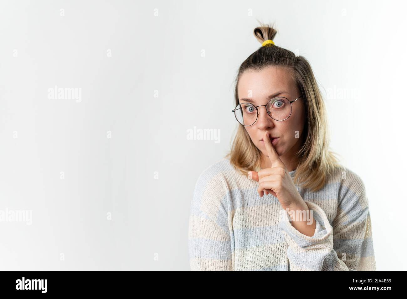 Young woman holding her finger on her mouth, asking for silence Stock ...