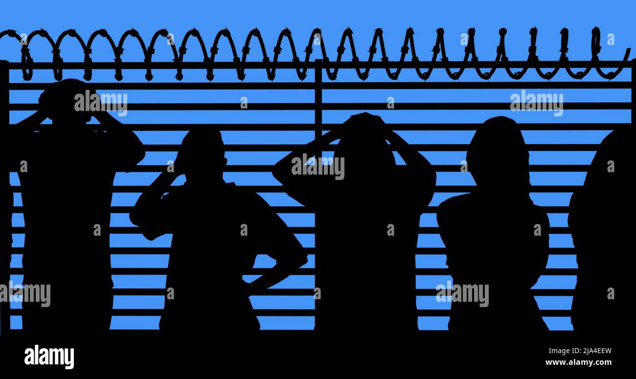 Image of people standing in front of fence with barbed wire Stock Photo ...