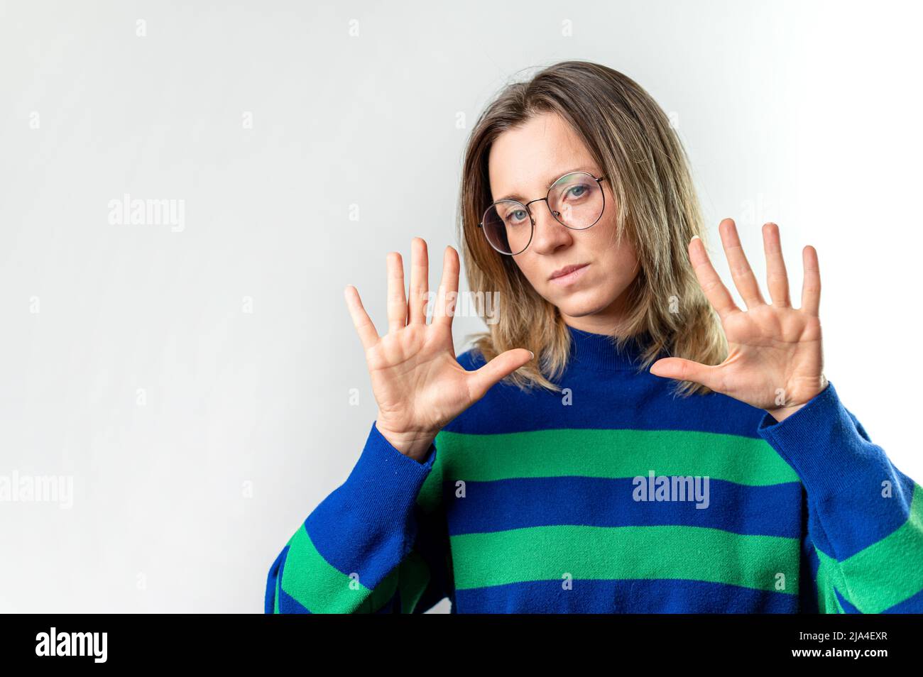 Young female holding hands in front of her as a stop sign Stock Photo ...