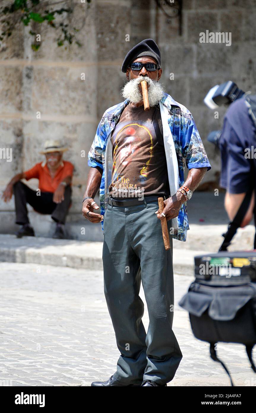 Bearded old cuban man smoking a big cigar, Cathedral Plaza, historic ...