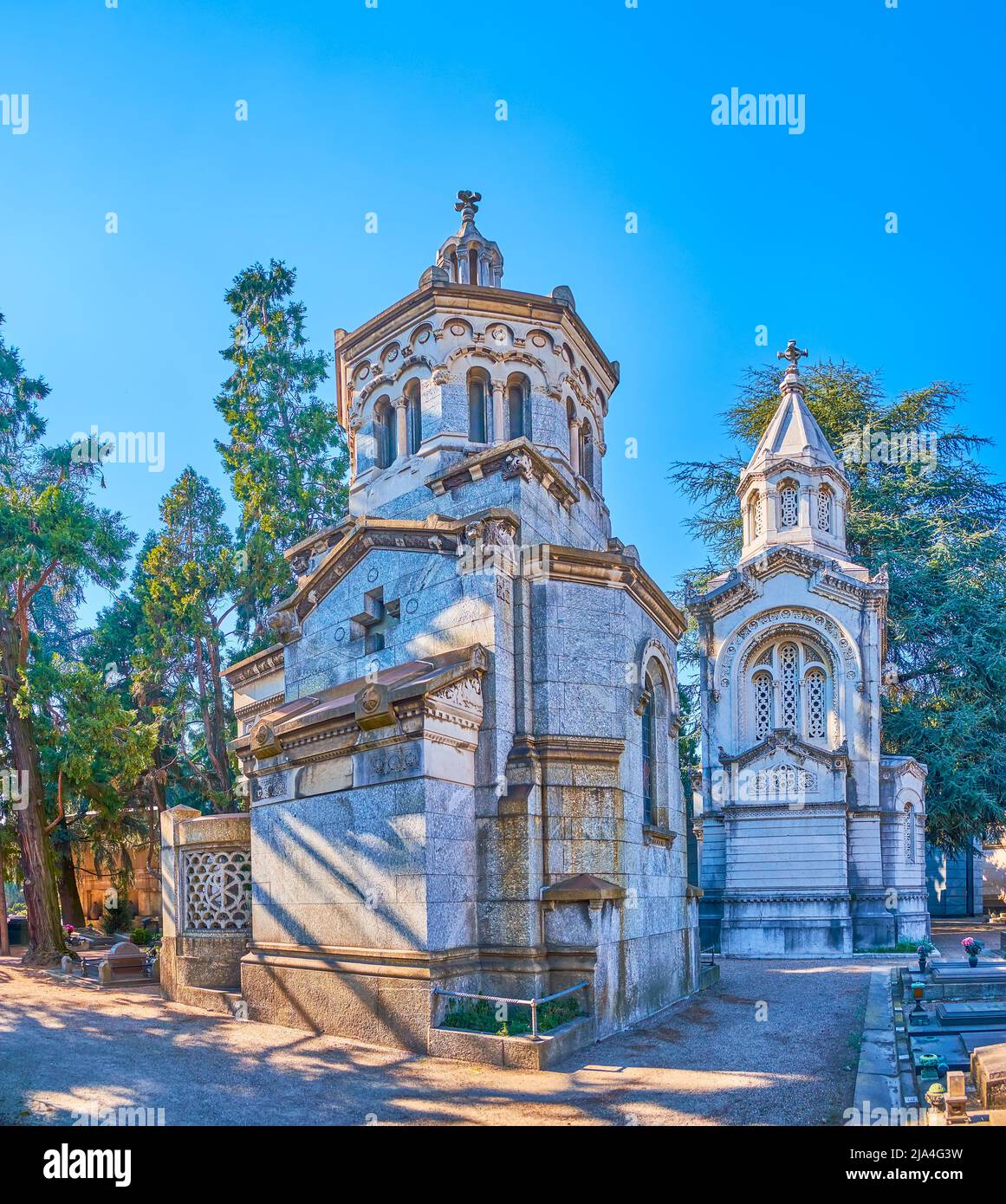 The stone funeral shrines among the trees in the Monumental Cemetery of ...