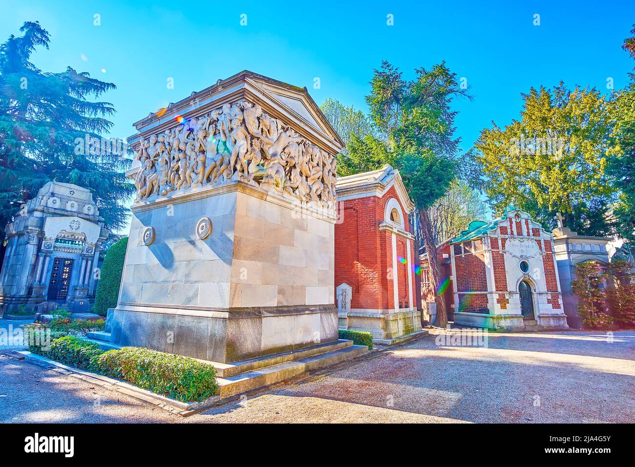 The line of old funeral tombs among lush park in Memorial Cemetery of ...