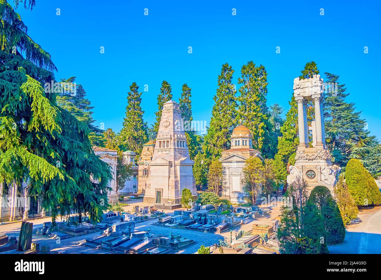 The view on the funeral tombs and mausoleums surrounding with trees of ...