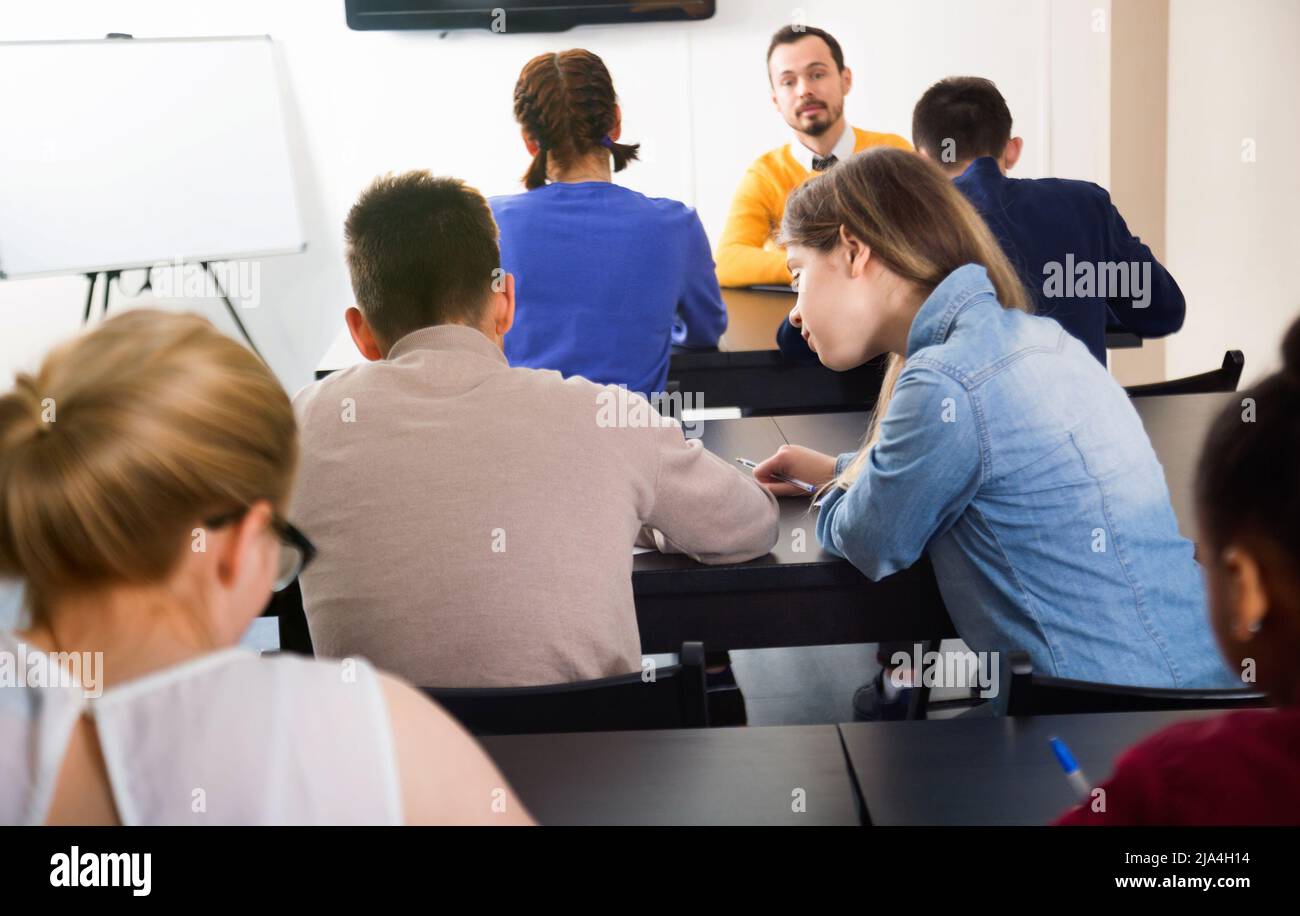 Female student looking at test variant of her neighbor Stock Photo - Alamy