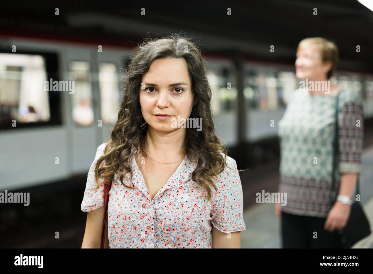Woman commuter waiting train on public transport station Stock Photo ...
