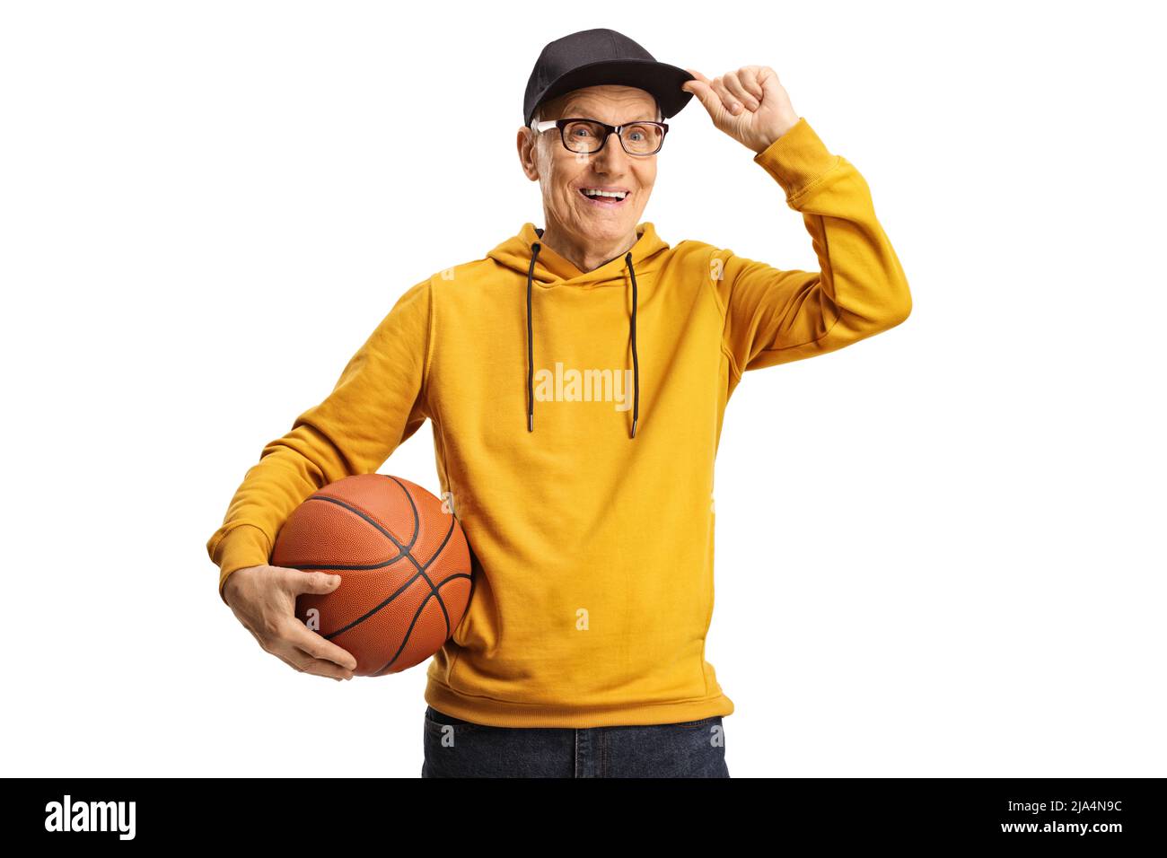 Cheerful elderly man holding a basketball and greeting with cap ... Cheerful elderly man holding a basketball and greeting with cap ...