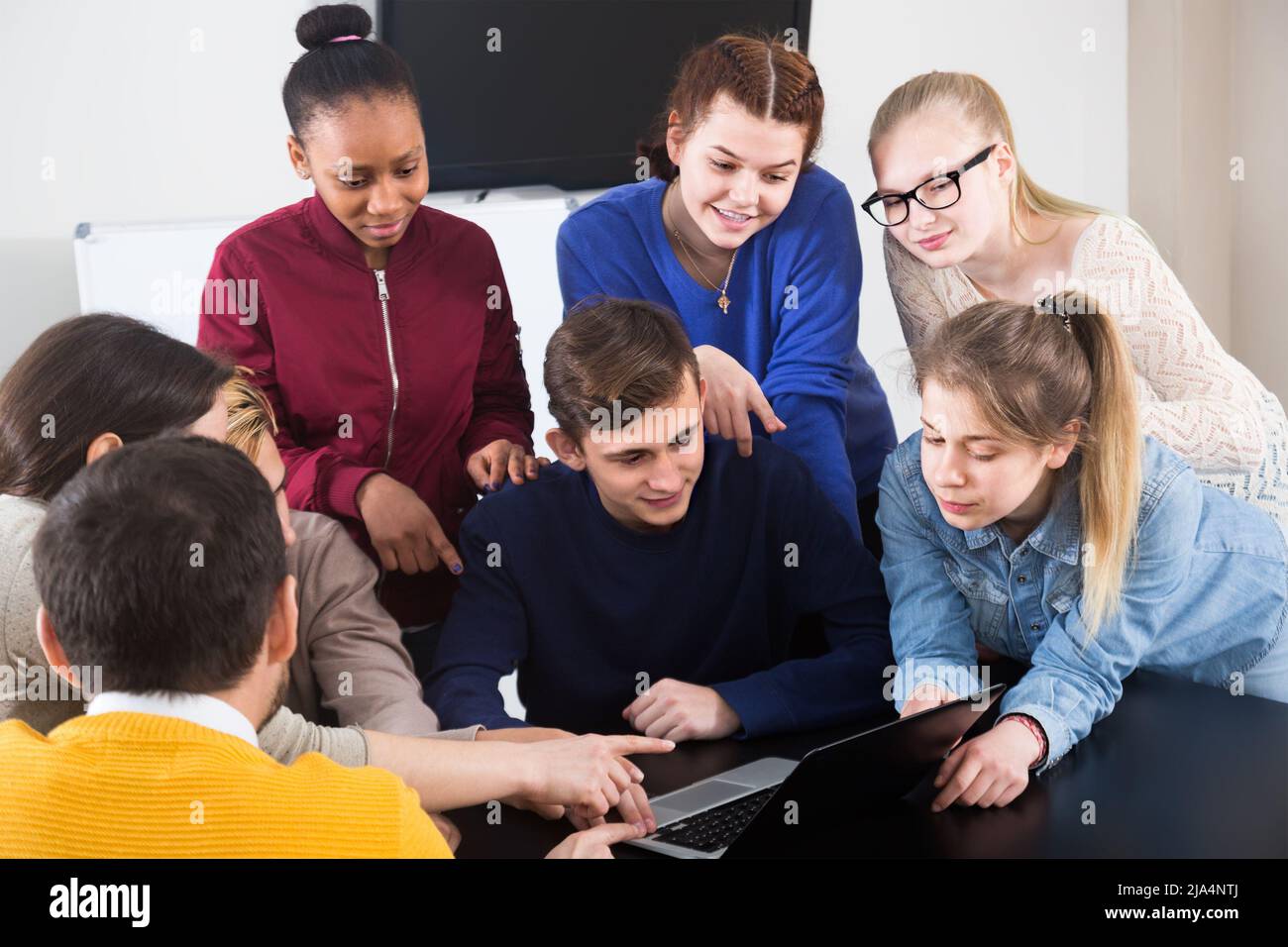 friendly classmates having difficult project to complete during class ...