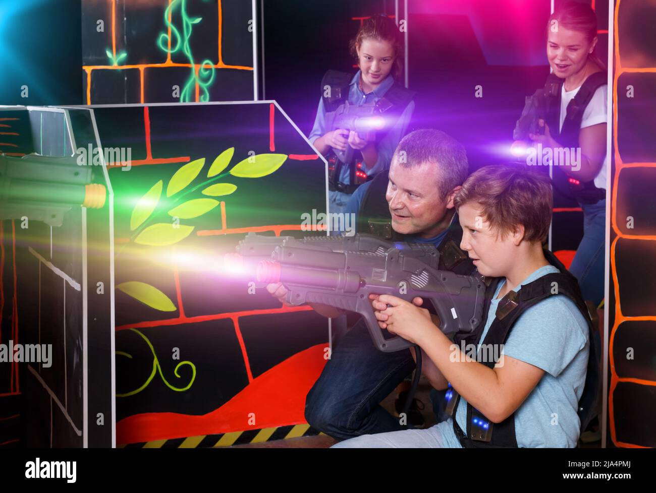 Cheery boy and his father aiming laser guns Stock Photo - Alamy