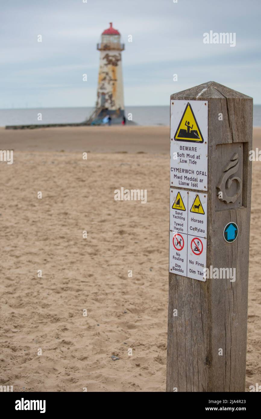 warning post and lighthouse in background Stock Photo - Alamy