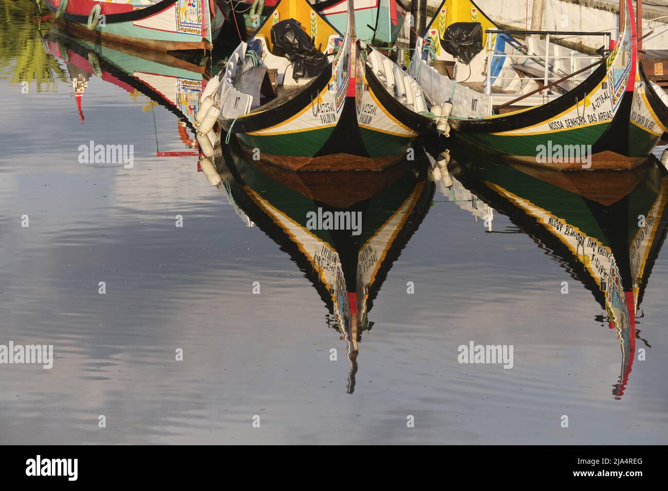 popular with tourists colorful Moliceiros boat moored along a canal in ...