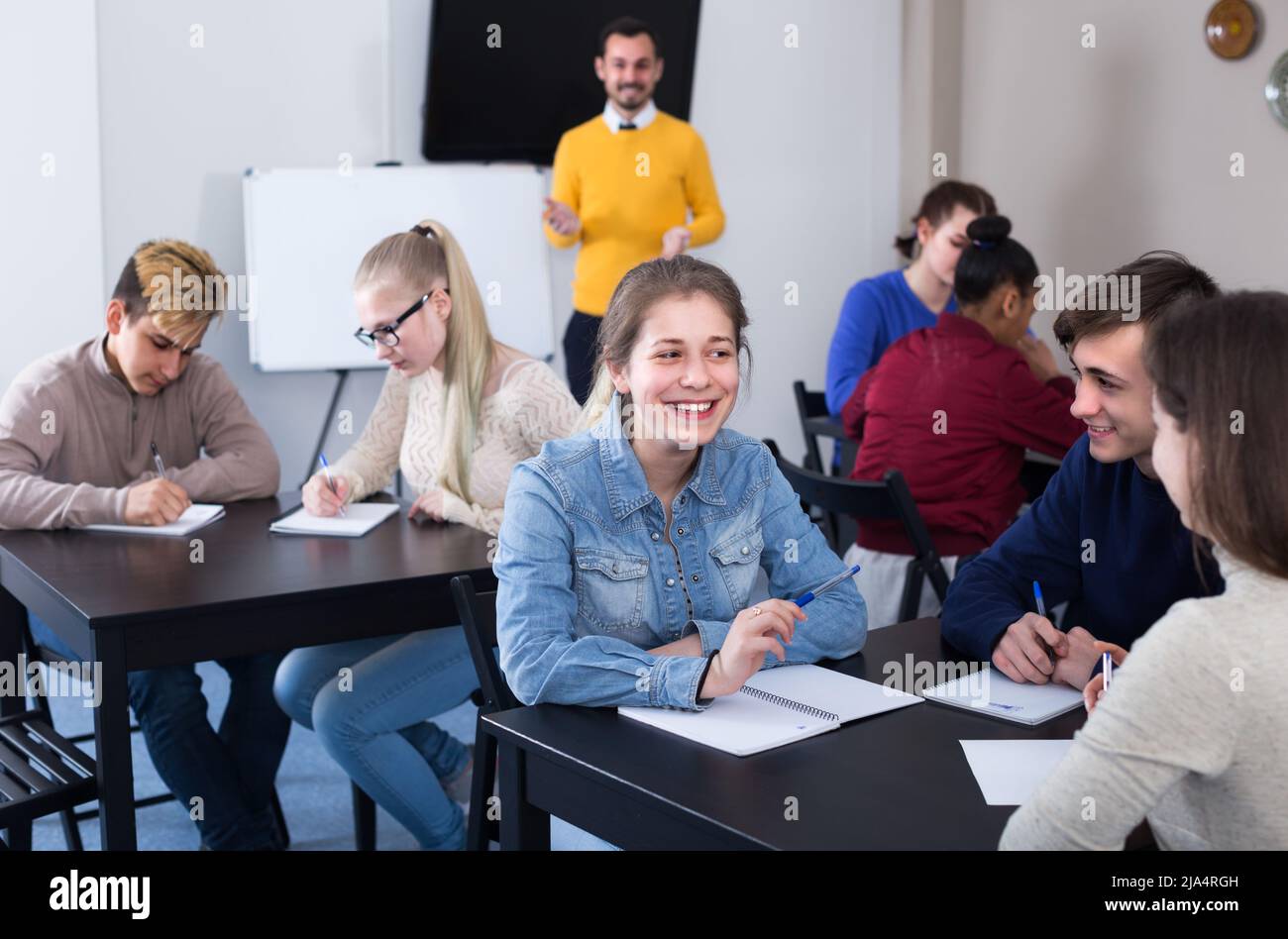 Young girls nad boys students are having group exercises Stock Photo - Alamy