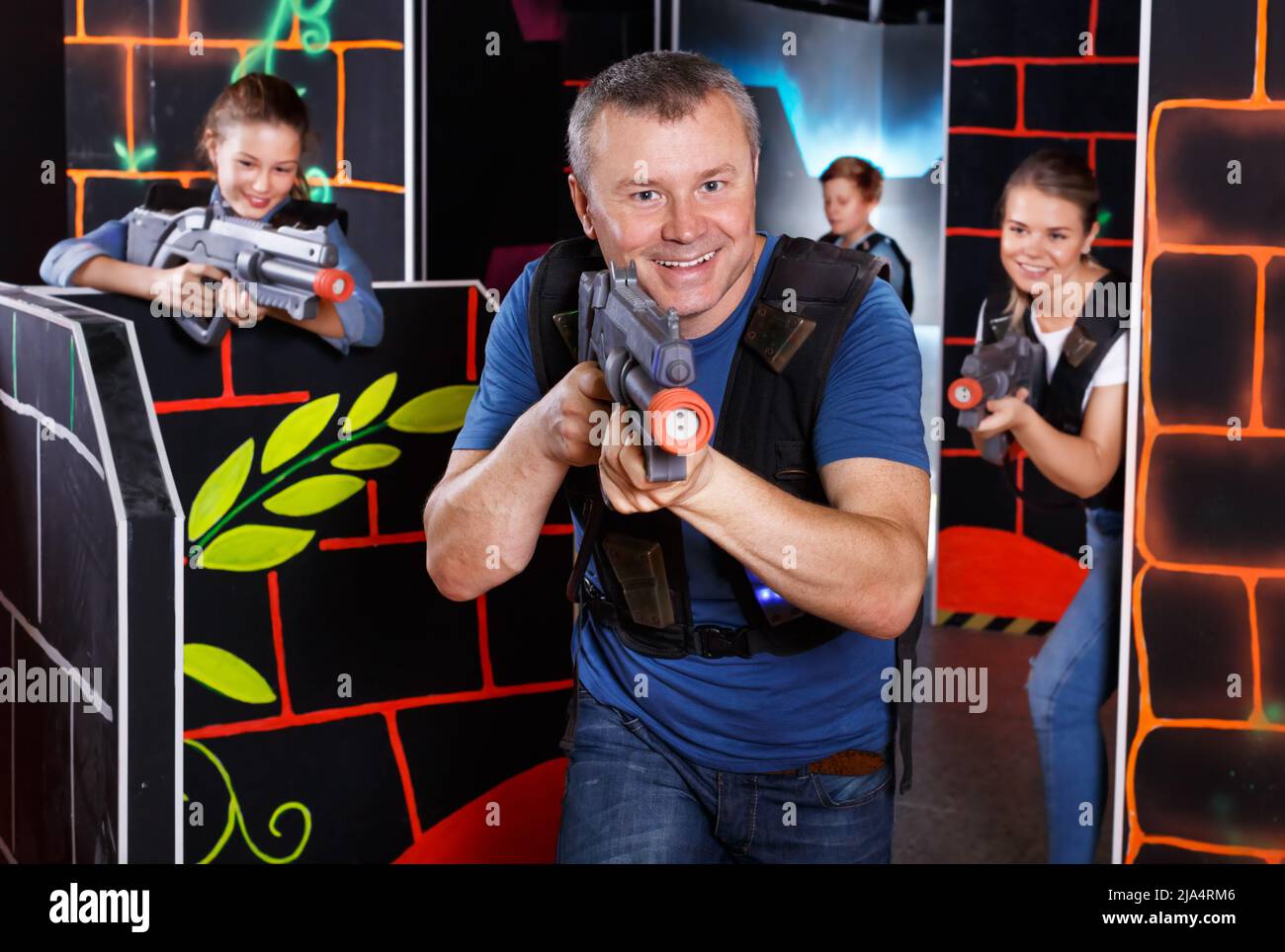 Man with laser pistol playing laser tag Stock Photo - Alamy