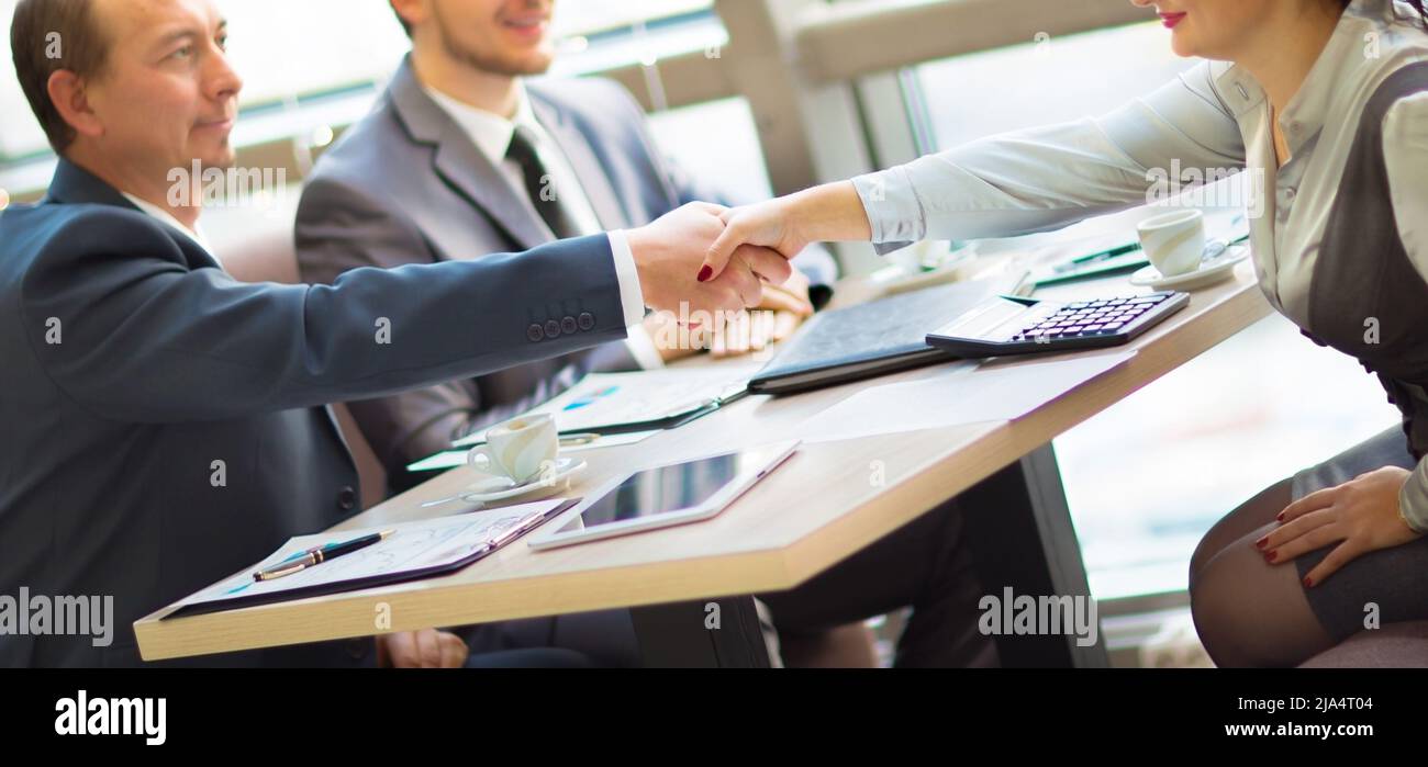 Business handshake. Handshake of two business men closing a deal at the ...