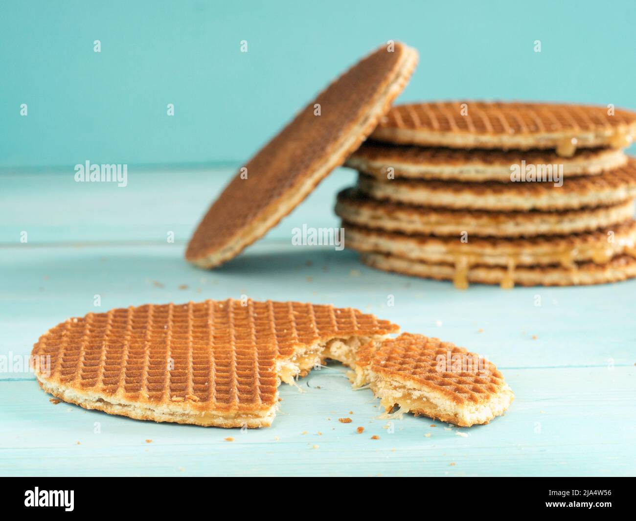 Stroopwafels or caramel Dutch Waffle close up on turquoise wooden ...