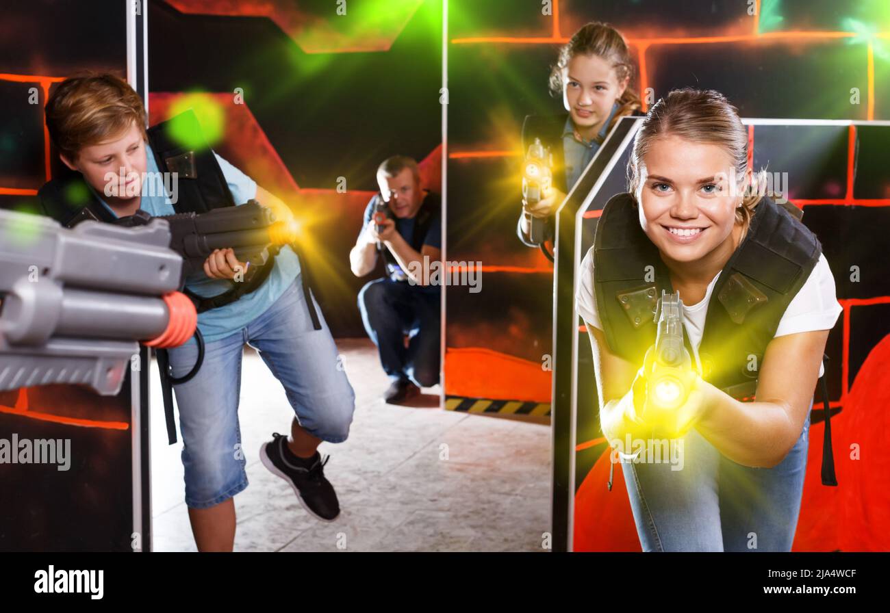 Woman playing lasertag with family Stock Photo - Alamy