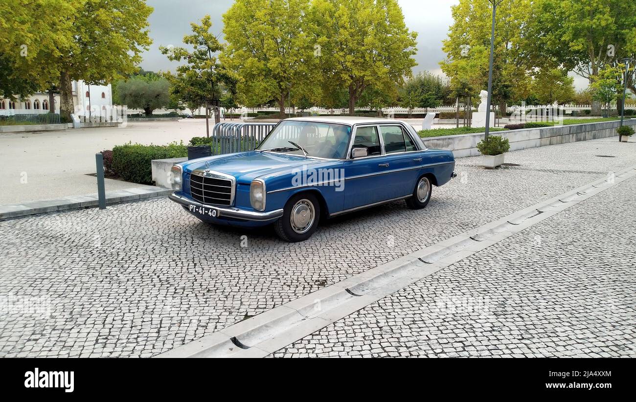 Blue classic 1960s-1970s W-class Mercedes-Benz sedan, parked on a ...