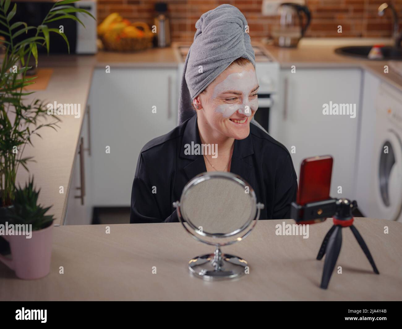 Famous blogger. Cheerful female vlogger showing beauty mask while ...