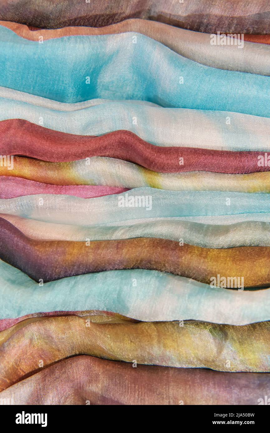 Multi-colored uzbek silk fabrics stacked Stock Photo - Alamy