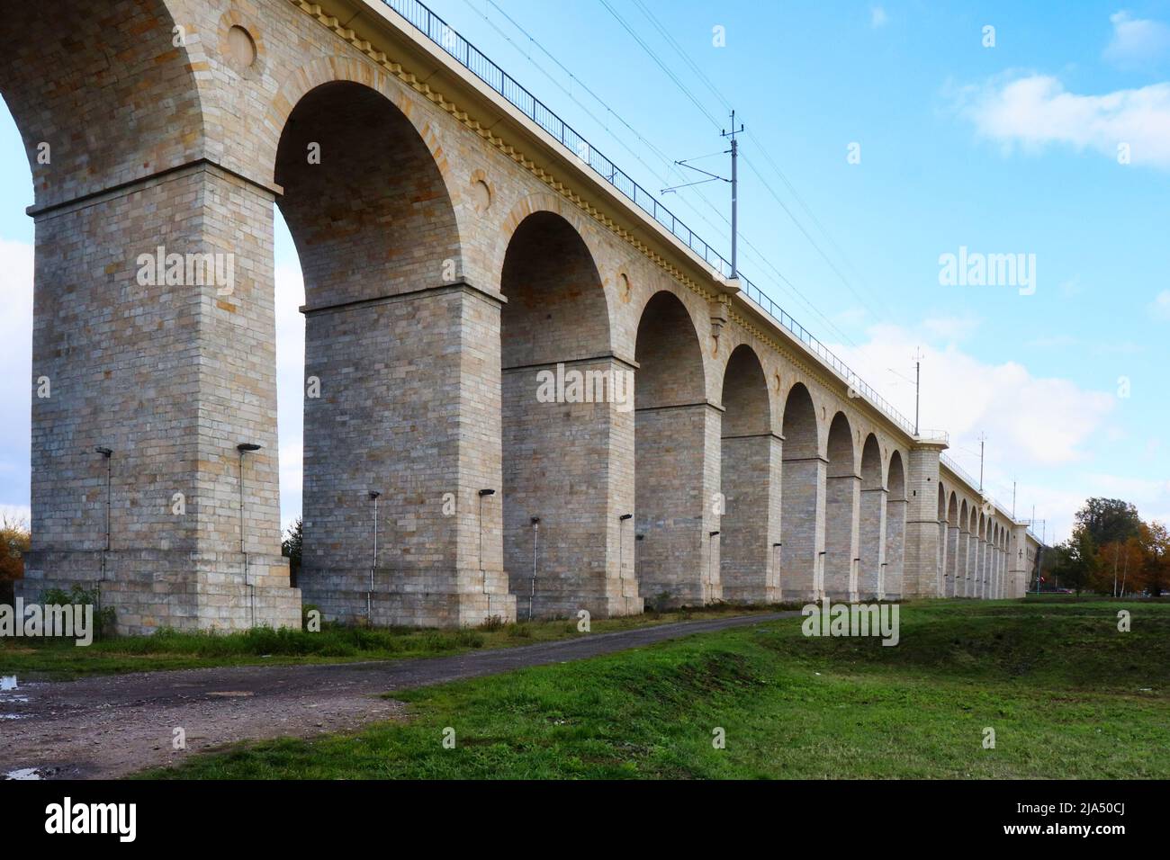 Long stretch of rail viaduct with arches on a fall day in Boleslawiec ...