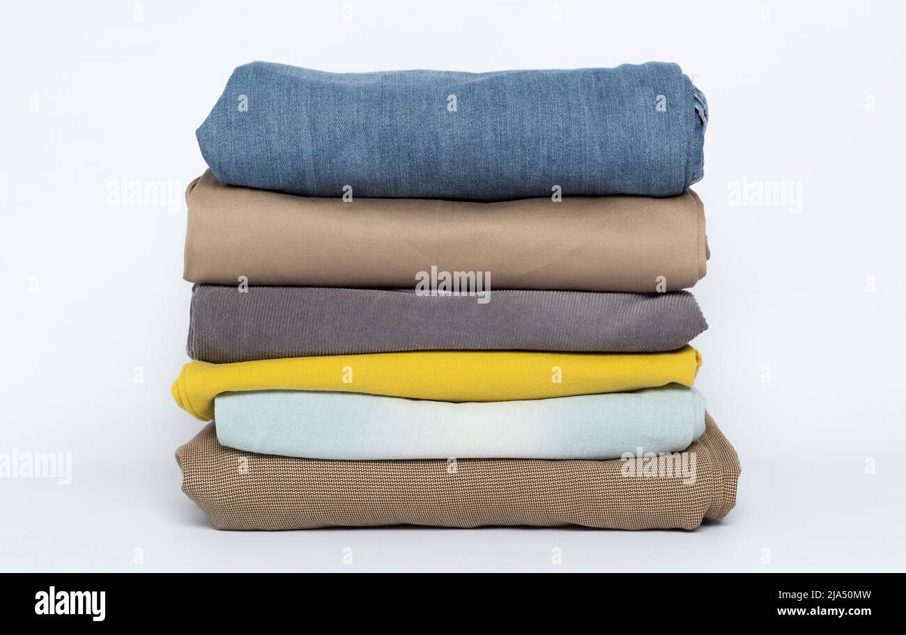 Stack of folded clothes on a white background Stock Photo - Alamy