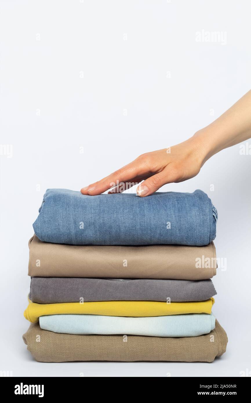 Stack of folded clothes on a white background Stock Photo - Alamy