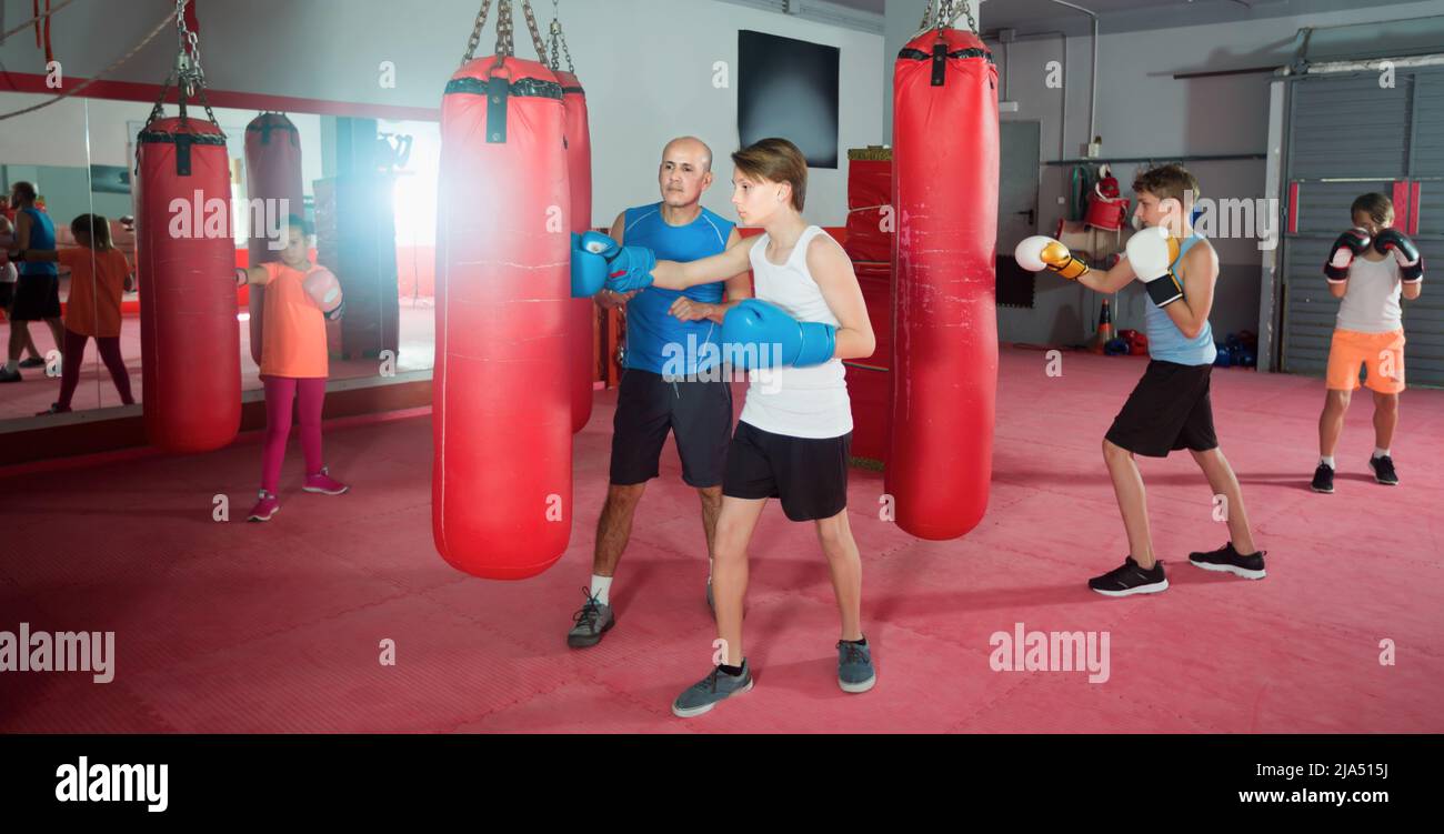 Teenagers at boxing workout with instructor Stock Photo - Alamy