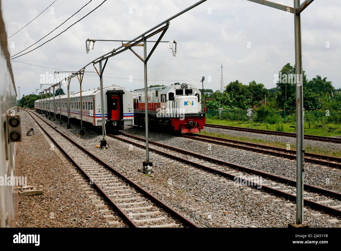 Locomotive and passanger train stopped at station in Java Island ...
