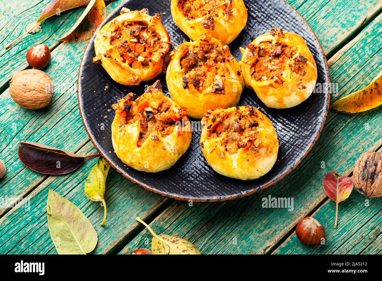 Autumn homemade pastries.Fresh buns with minced meat and pumpkin Stock ...