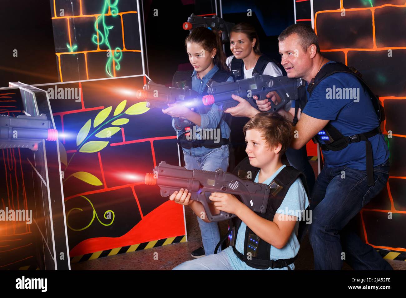 Kids and adults playing lasertag Stock Photo - Alamy