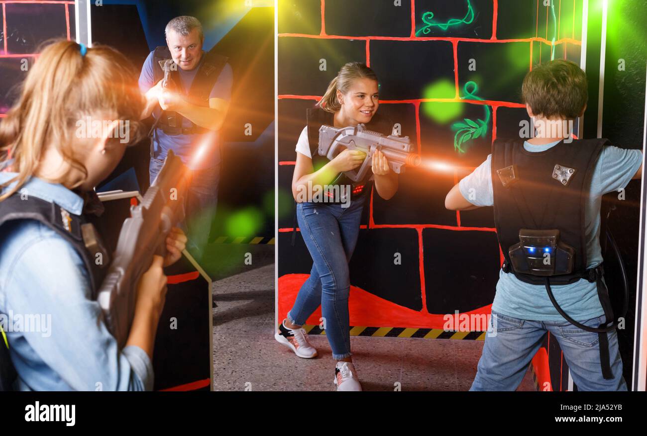 Children and parents aiming laser guns at other players during l Stock ...