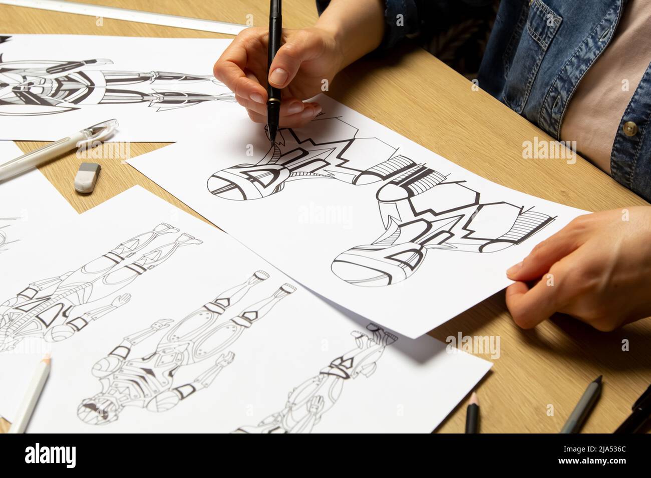 The illustrator draws sketches of robot computer game characters. The ...