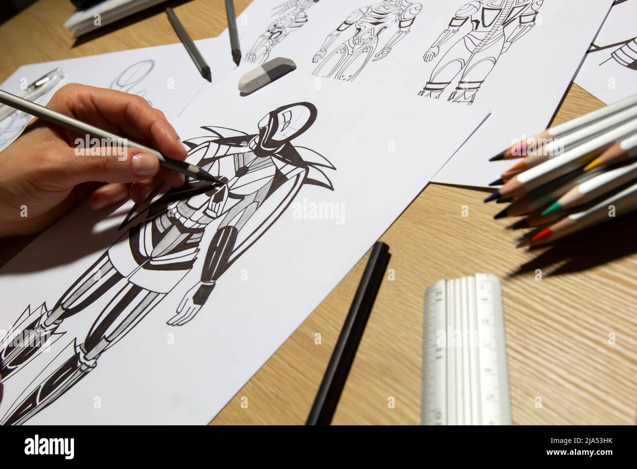 The illustrator draws sketches of robot computer game characters. The ...